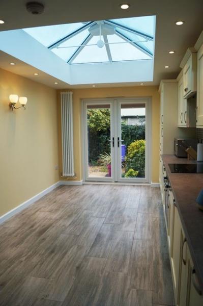 Orangery-style home extension with blocked paving overlooking the ...